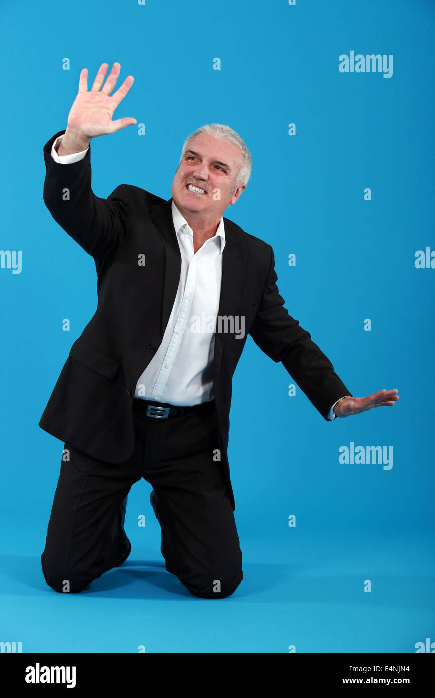 Senior man pushing invisible object Stock Photo - Alamy