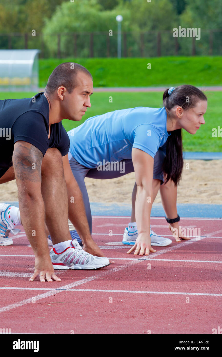 Man and woman on the starting line Stock Photo - Alamy