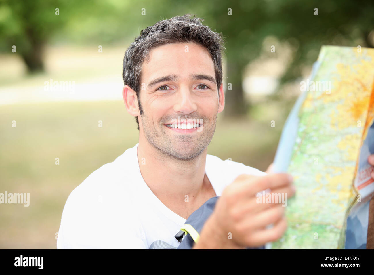 young man with map Stock Photo - Alamy