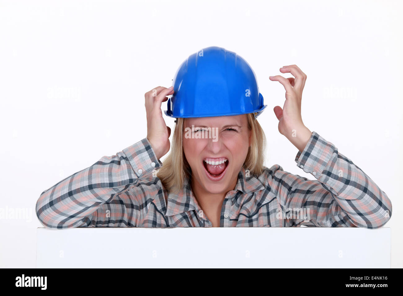 Screaming female construction worker Stock Photo - Alamy