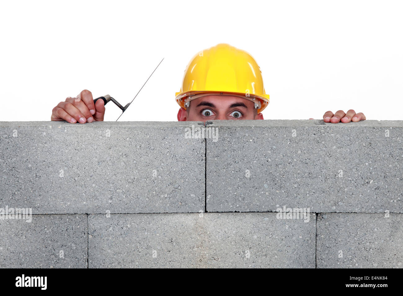 Workers peeking behind wall Stock Photo - Alamy