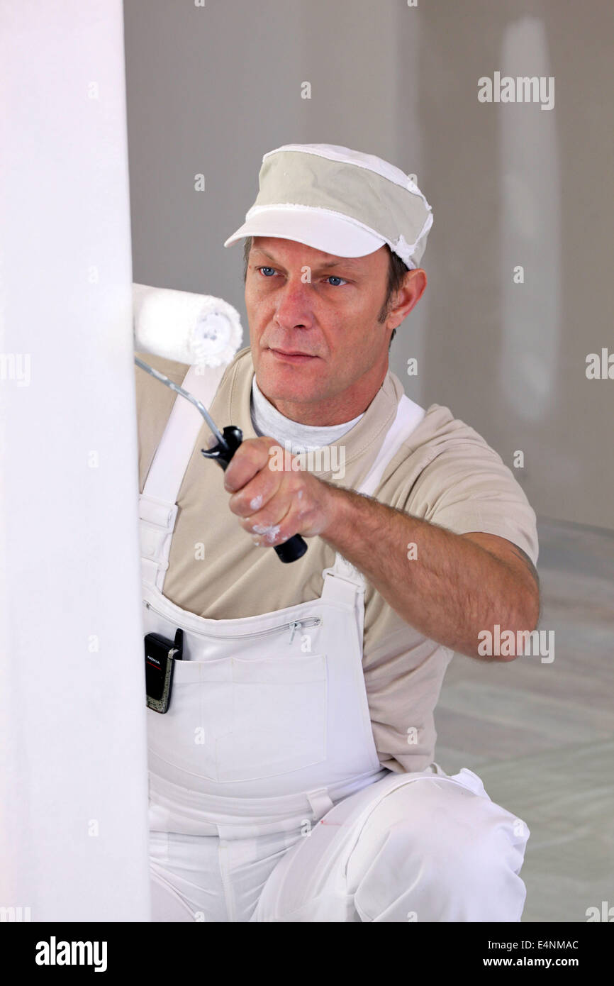 Man painting a wall Stock Photo - Alamy