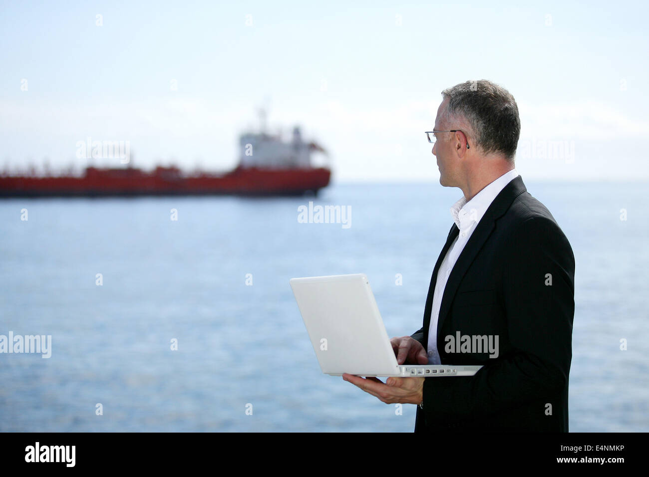 Businessman outdoors with computer Stock Photo - Alamy
