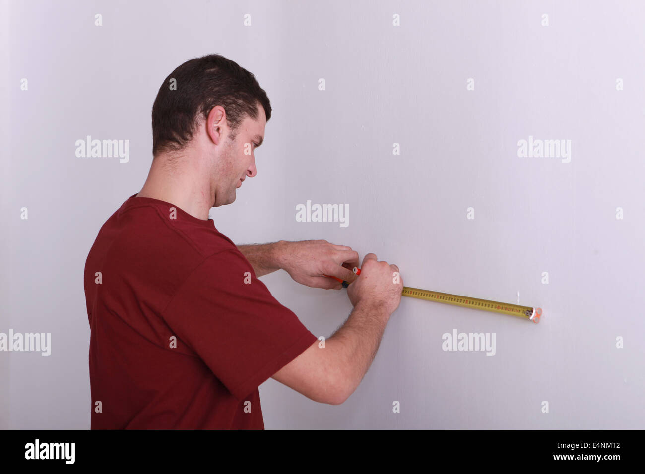 Man measuring wall Stock Photo - Alamy