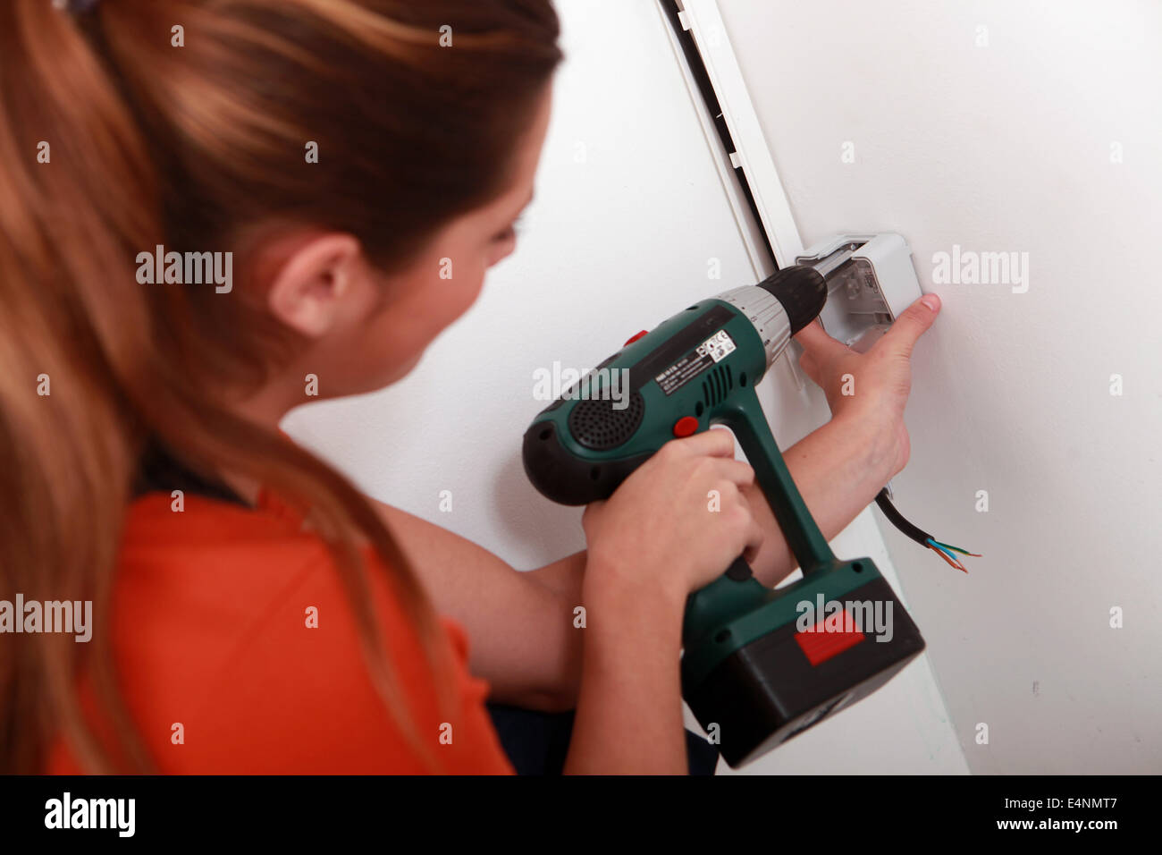 Woman using power drill Stock Photo - Alamy