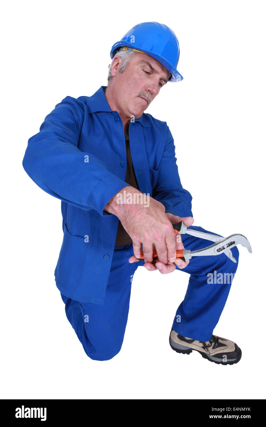 Man holding spanner in Cut Out Stock Images & Pictures - Alamy