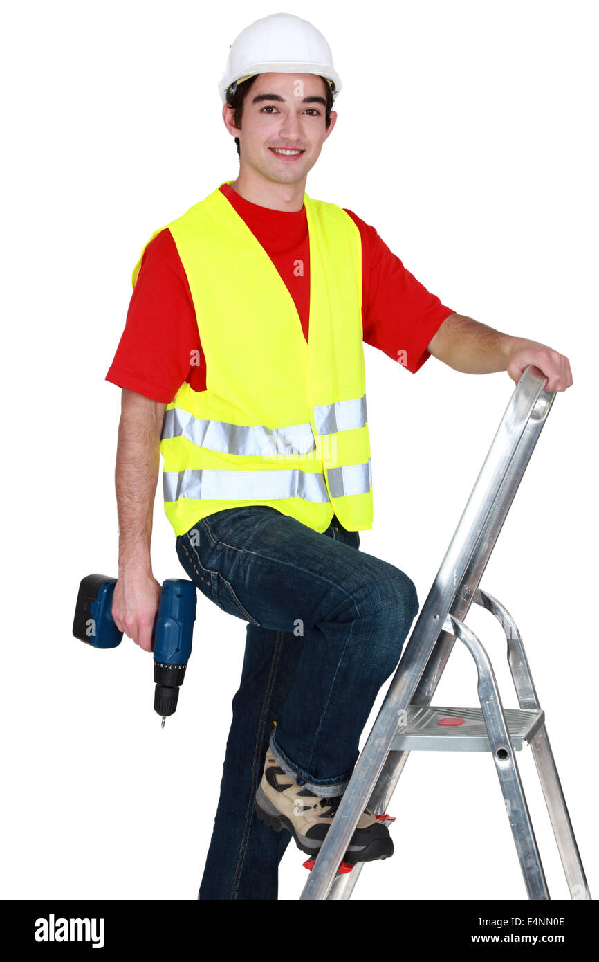 Man standing on ladder with drill Stock Photo - Alamy