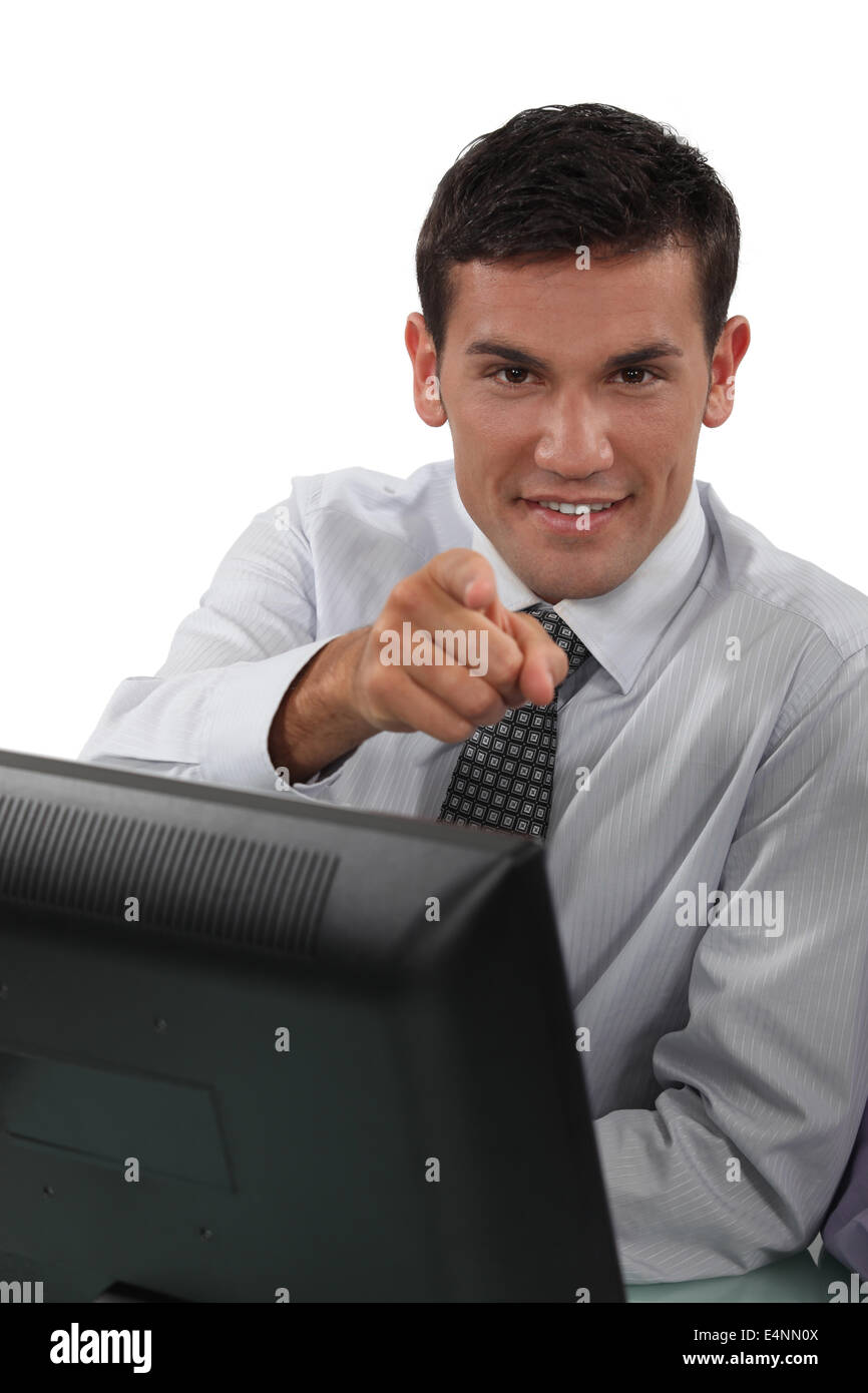 Businessman sat at desk pointing Stock Photo - Alamy