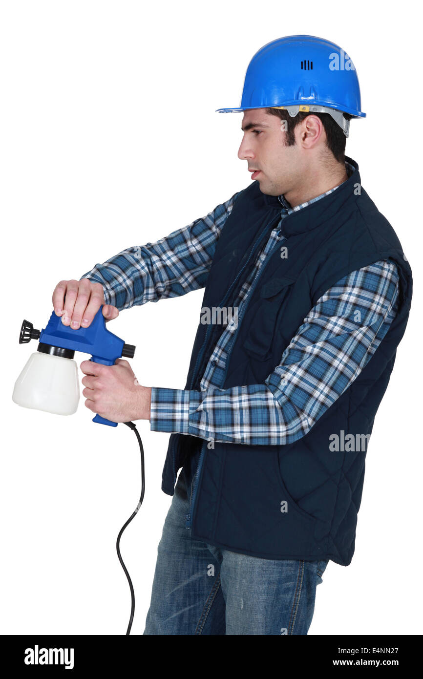 Man using paint sprayer Stock Photo - Alamy