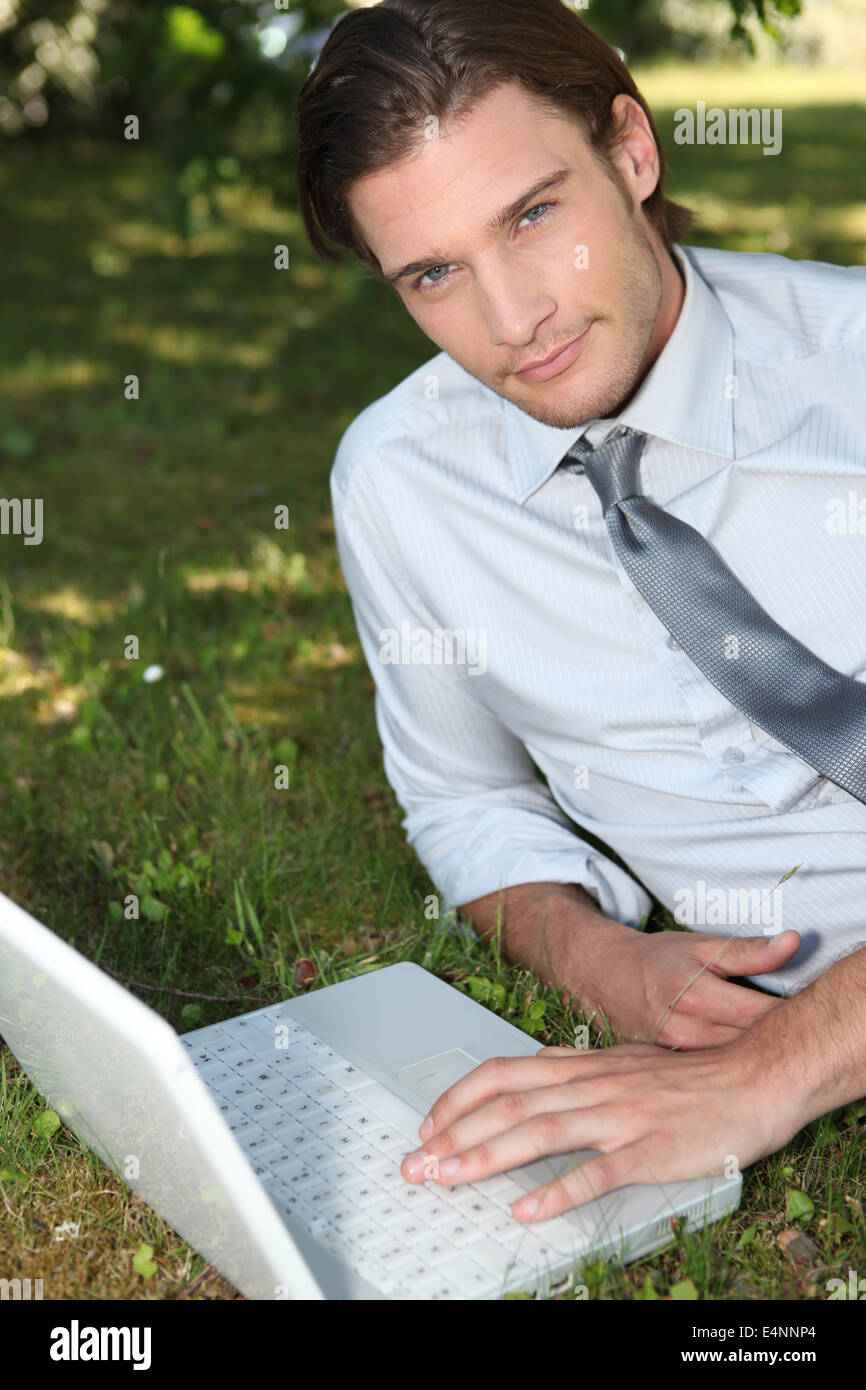 With computer on the grass Stock Photo - Alamy