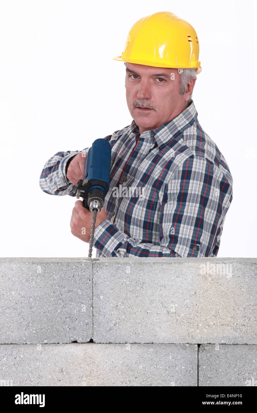Tradesman using a power tool Stock Photo - Alamy