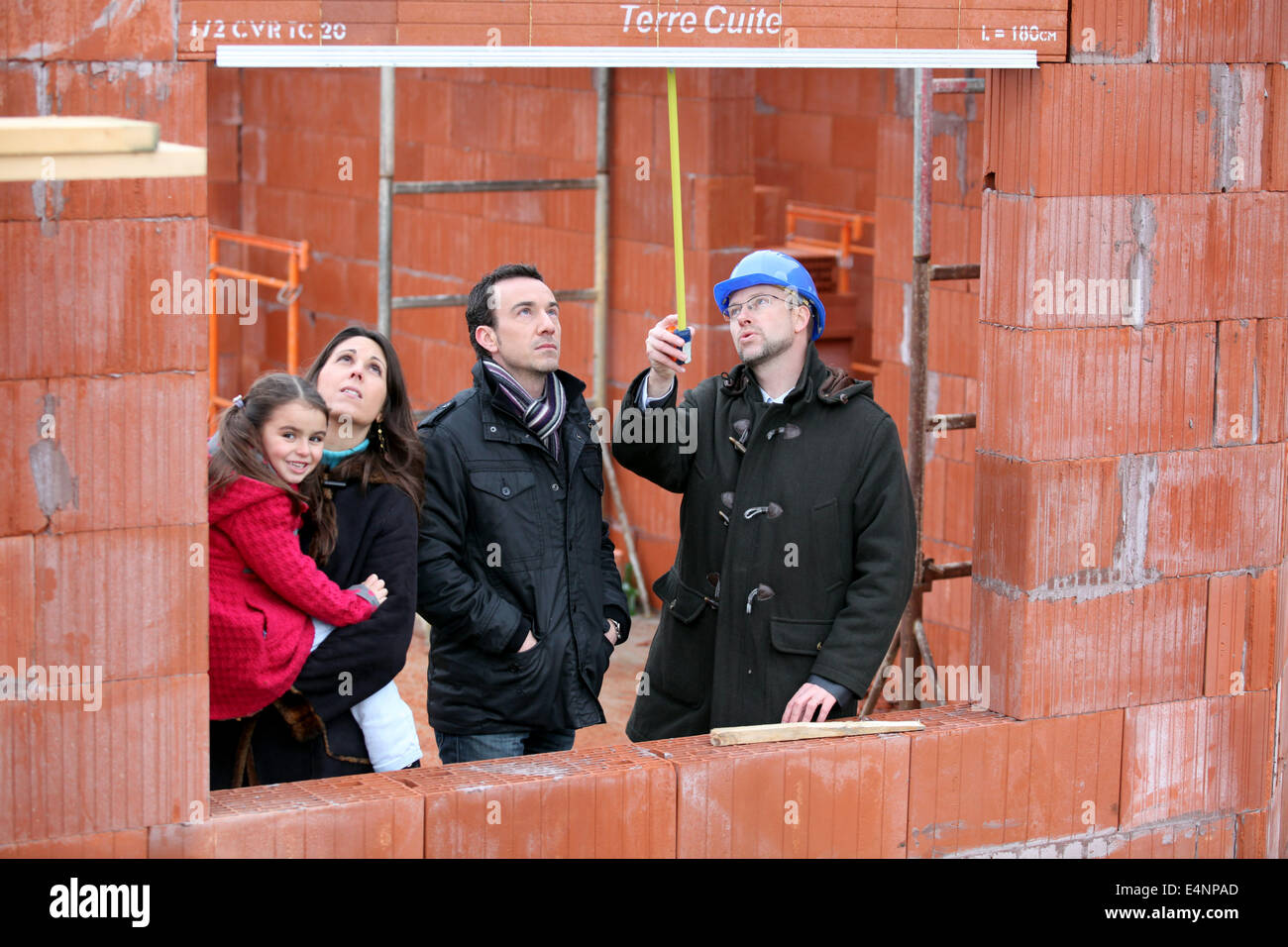family and contractor on construction site Stock Photo - Alamy