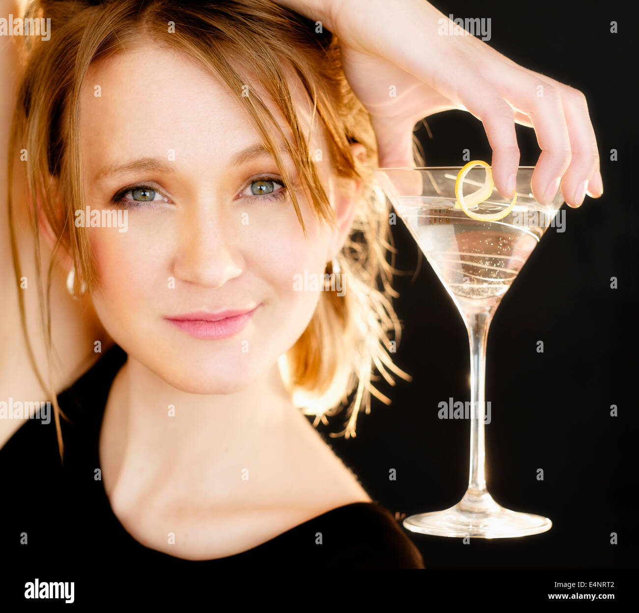 Portrait of woman holding martini glass Stock Photo - Alamy