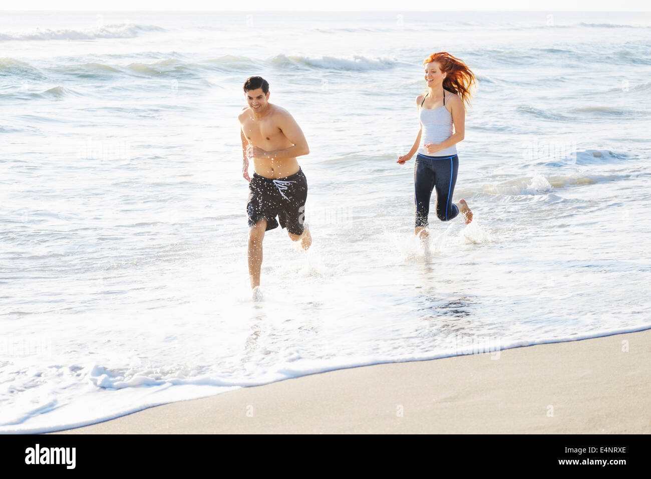 USA, Florida, Palm Beach, Couple running on beach Stock Photo - Alamy