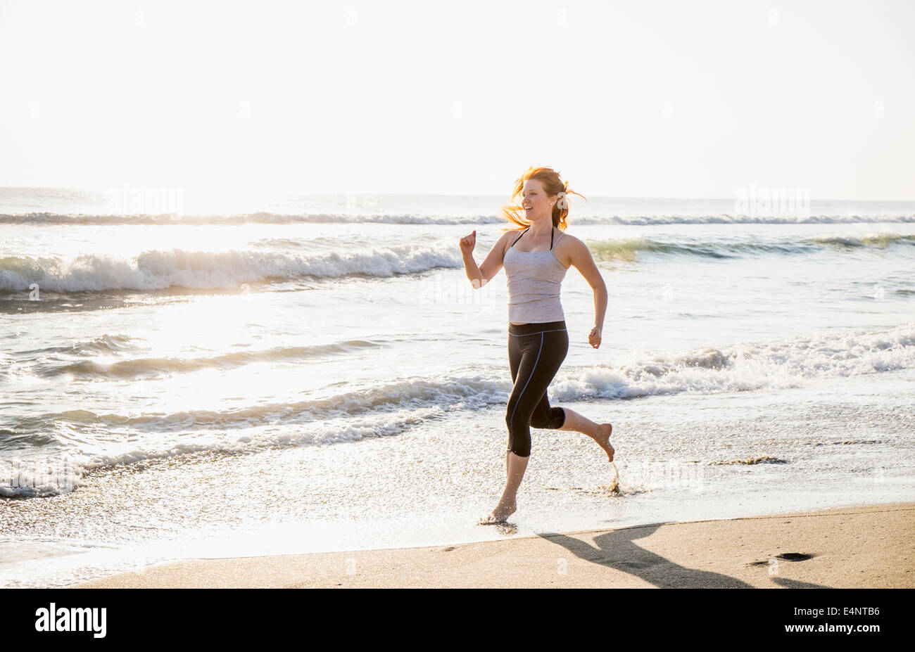 USA, Florida, Palm Beach, Woman running on beach Stock Photo - Alamy
