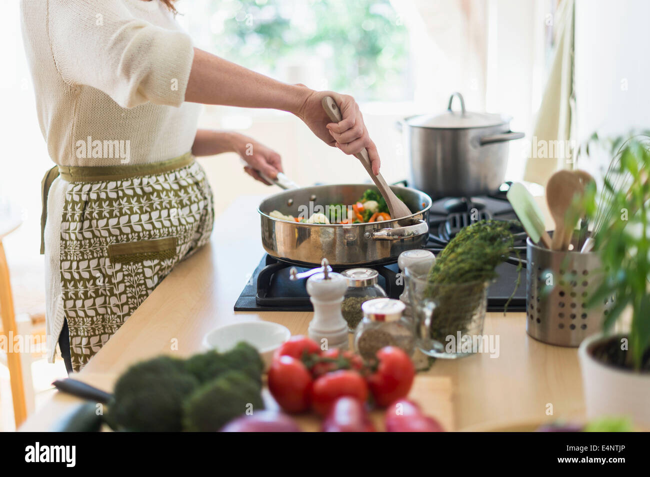 Woman cooking in kitchen Stock Photo - Alamy