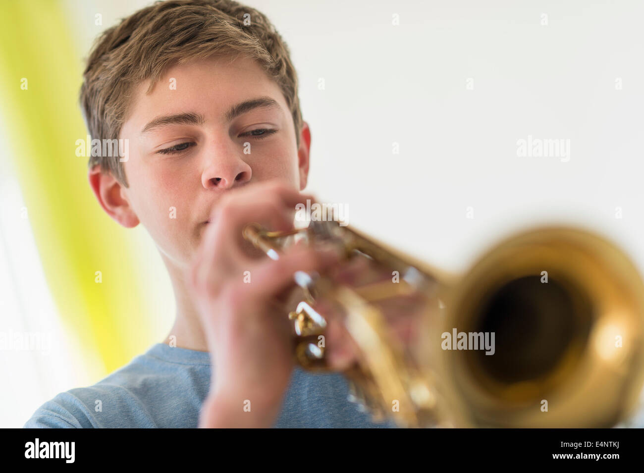 Teenage boy (16-17) playing trumpet Stock Photo - Alamy