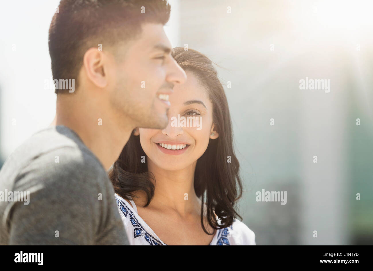 Young couple smiling in sunlight Stock Photo - Alamy