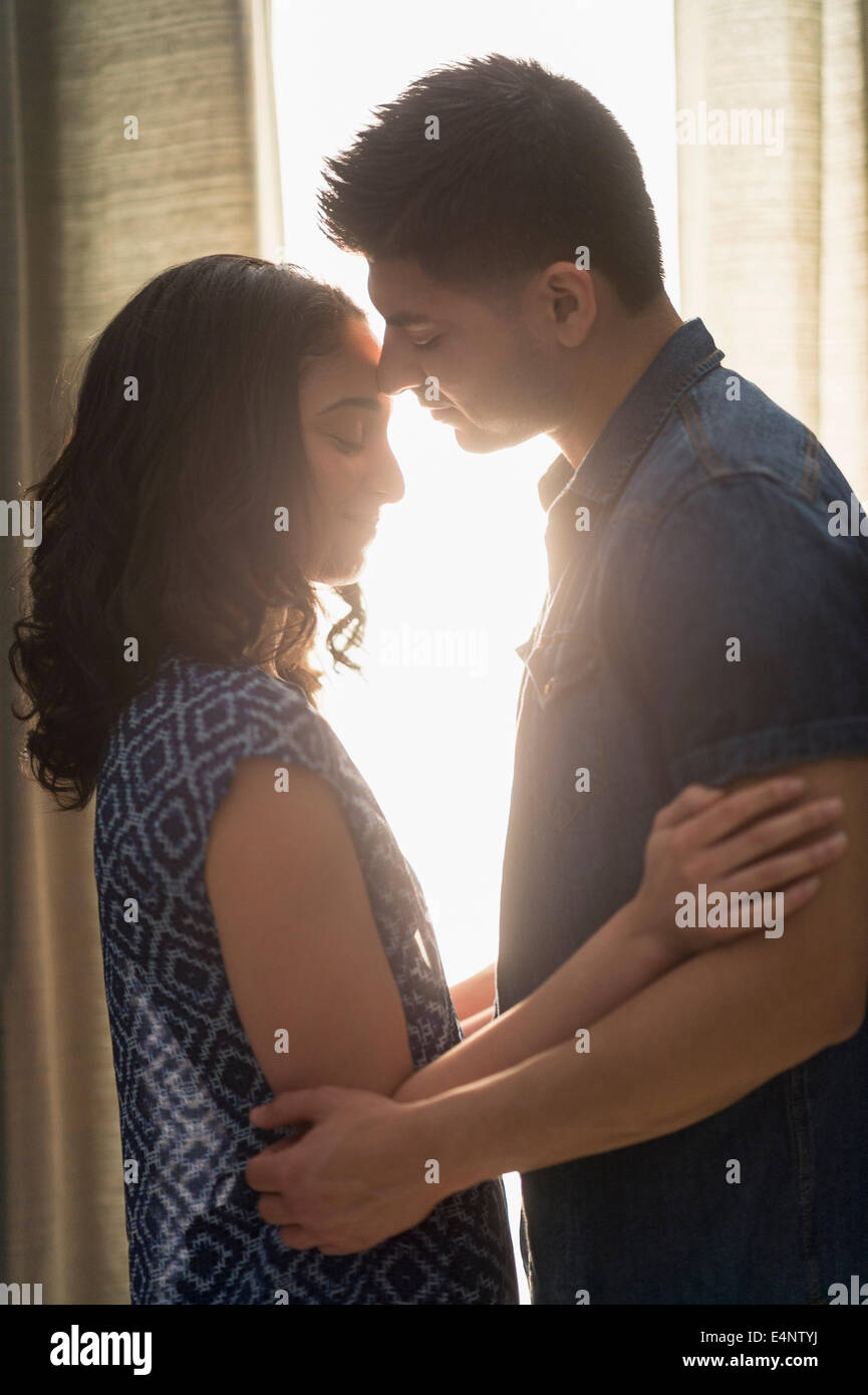 Young couple embracing in sunlight Stock Photo - Alamy