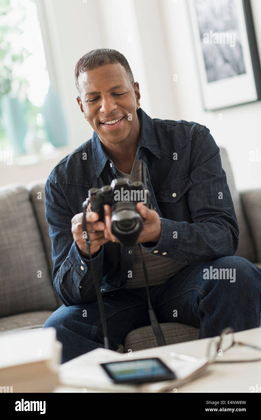 Man holding digital camera Stock Photo - Alamy