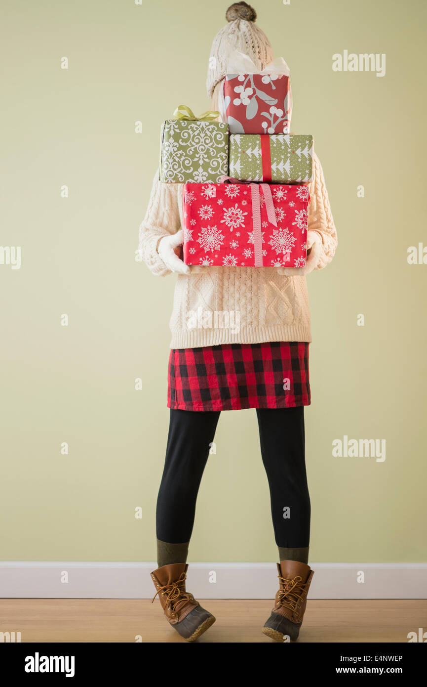 Woman holding stack of presents Stock Photo - Alamy