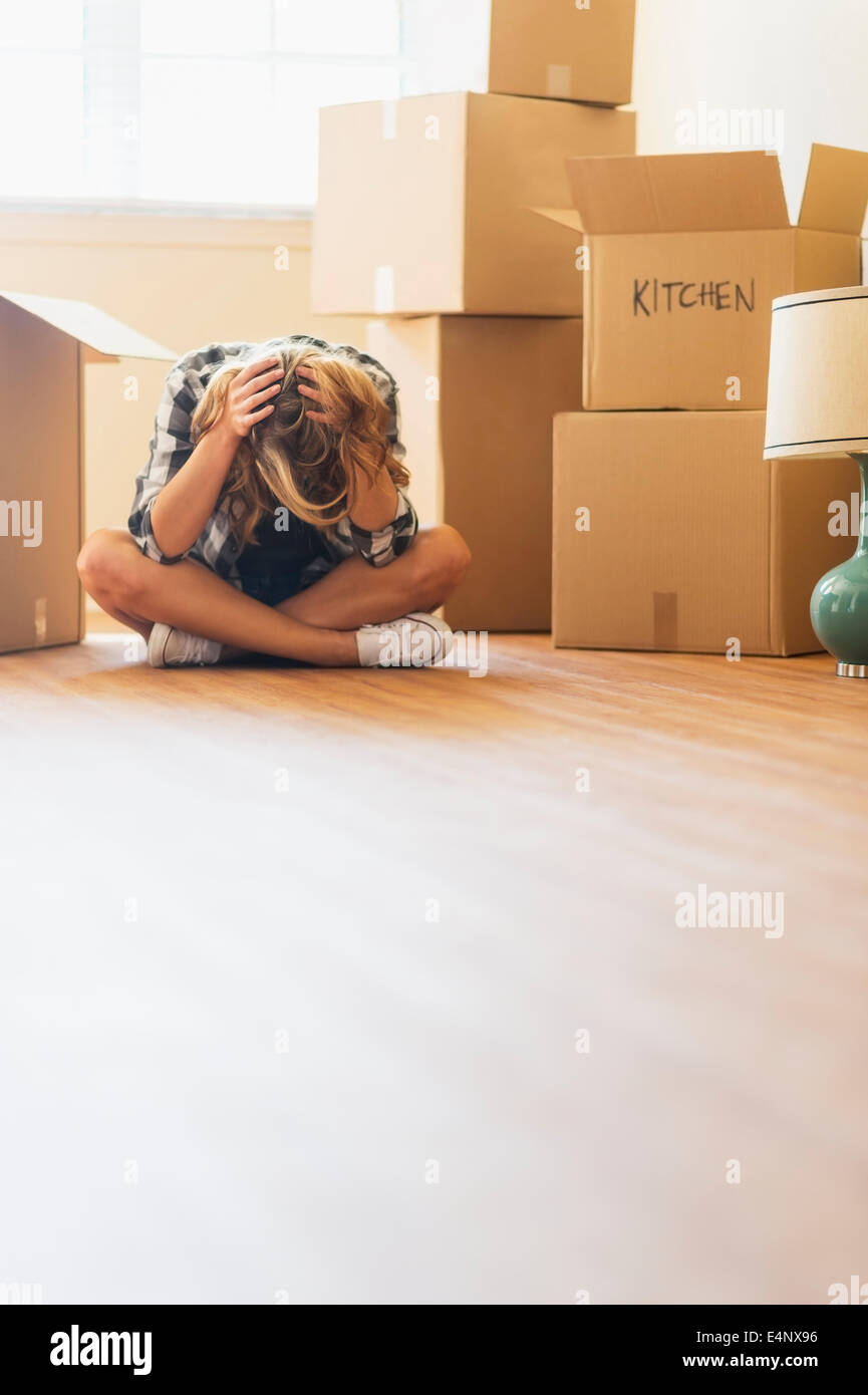 Sad woman packing boxes hi-res stock photography and images - Alamy