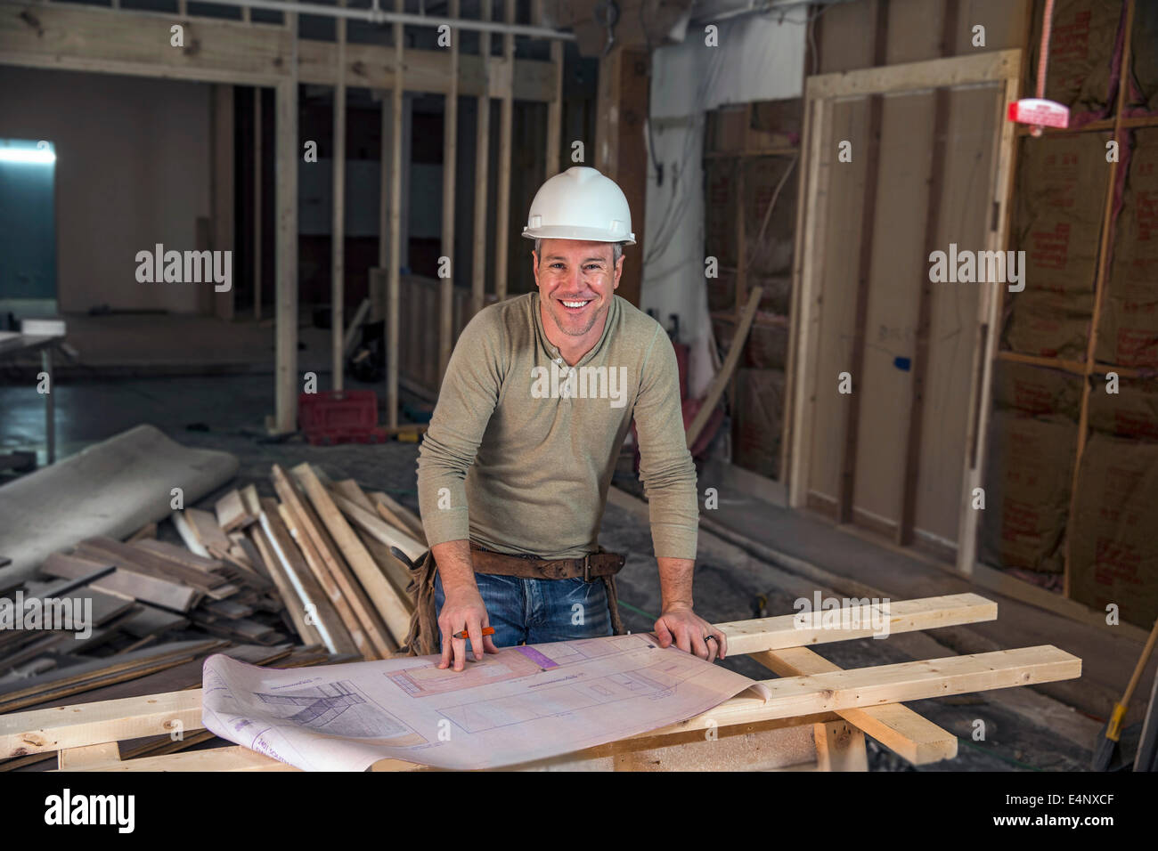 Portrait of engineer examining blueprint inside new structure Stock ...