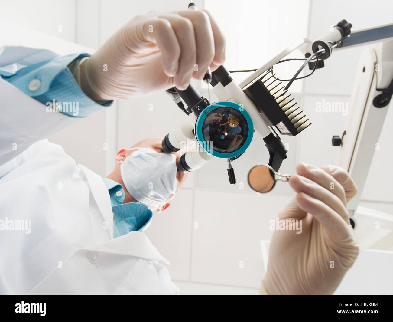 Lowe angle view of dentist using microscope Stock Photo - Alamy