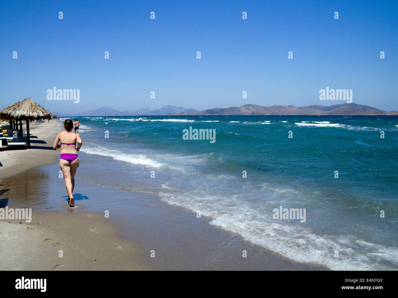 People running along Tingaki Beach, Tingaki, Kos Island, Greece Stock ...