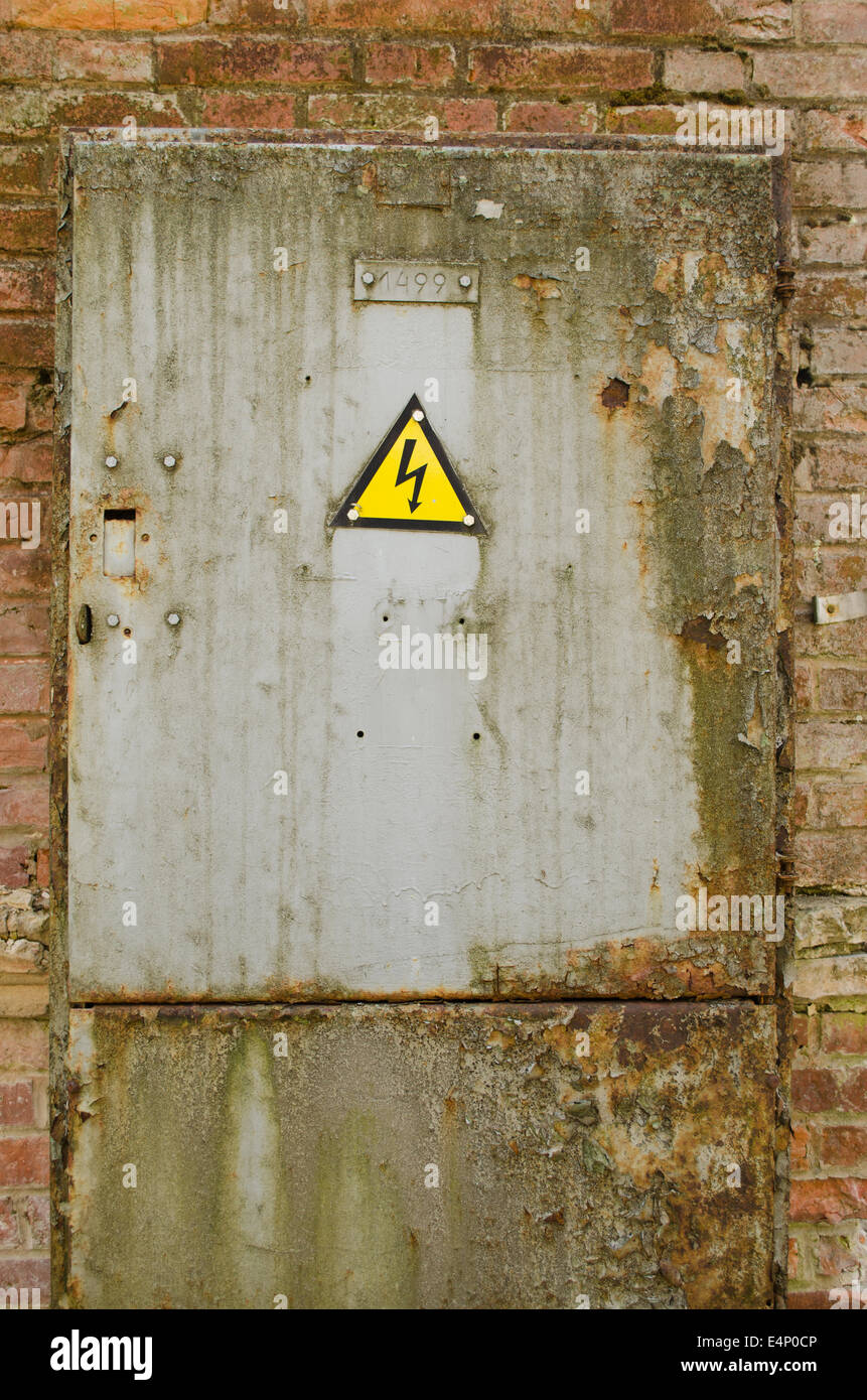 small iron door with yellow warning sign of danger Stock Photo - Alamy