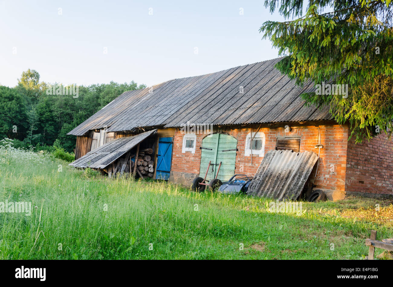 old rustic brick outbuilding with colored doors rural meadow Stock ...