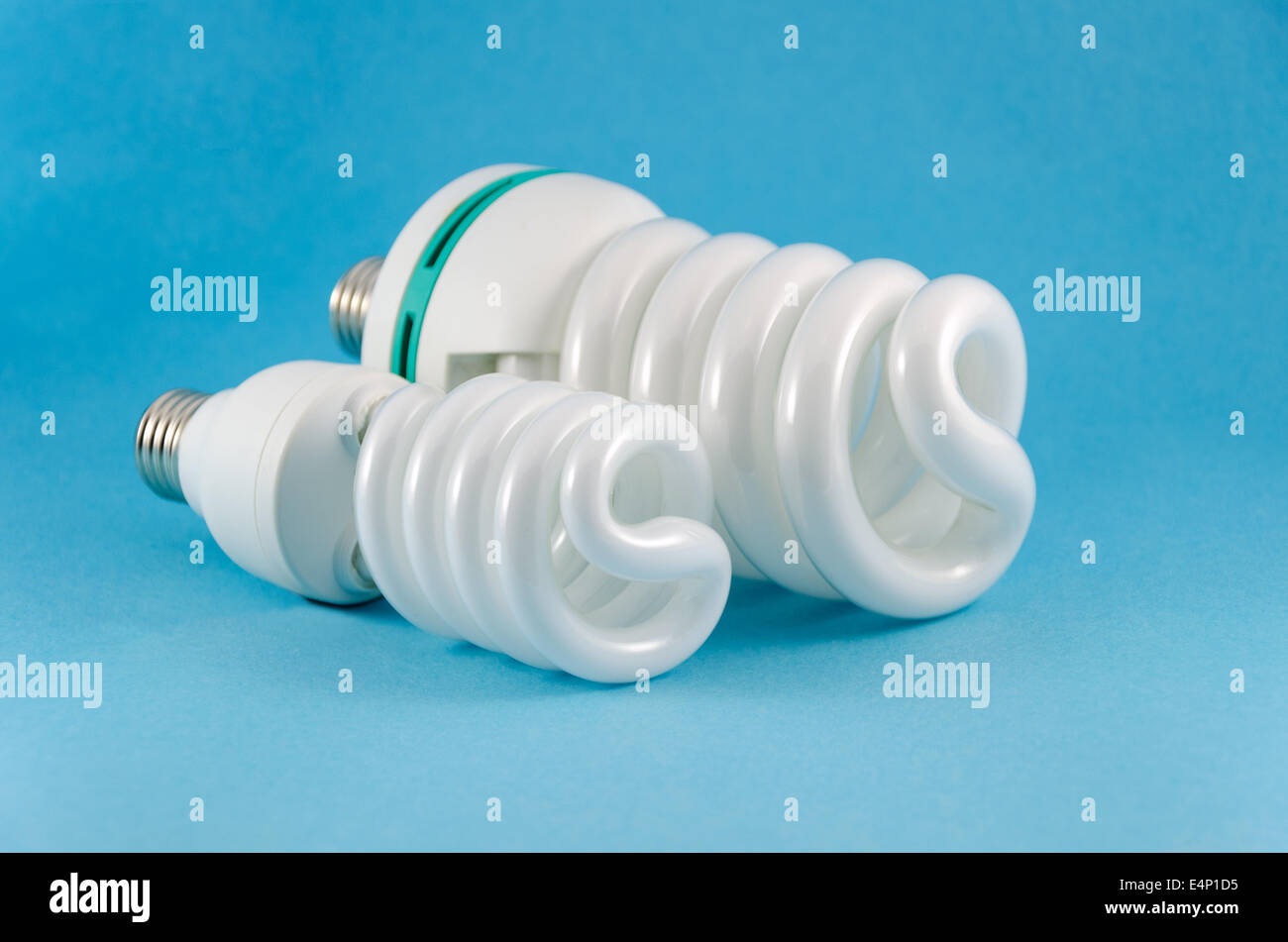 two energy saving eco lamp on blue background Stock Photo - Alamy