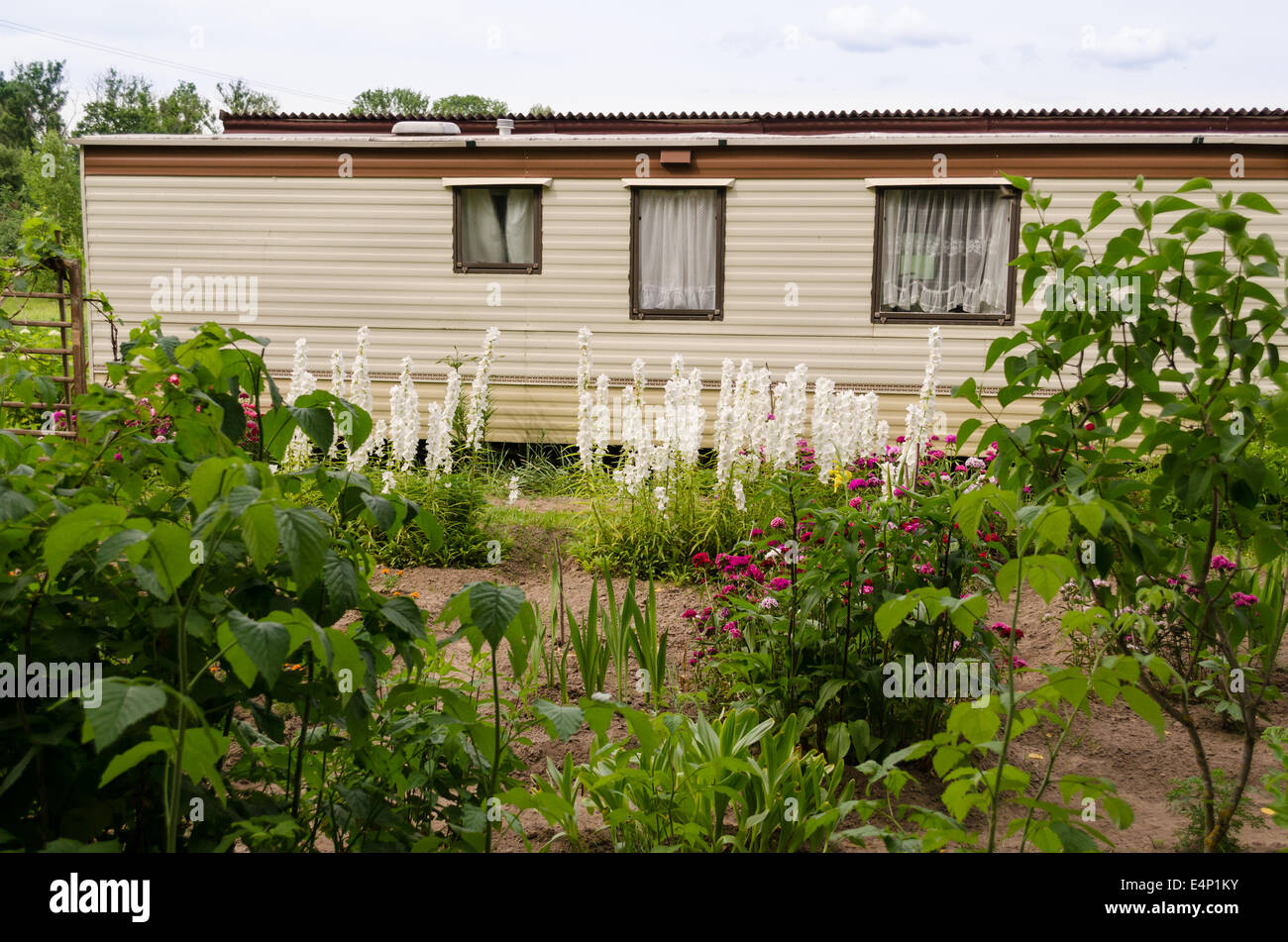 coach travel mobile trolley house in garden between the flowers in ...