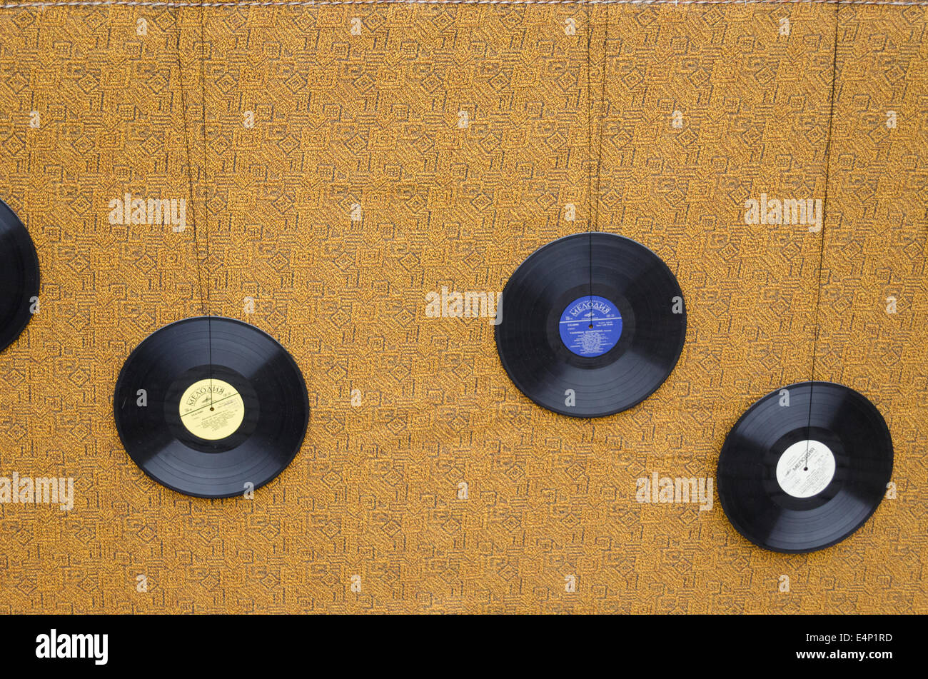 wall covered with thick tapestry material decorated with musical plates ...