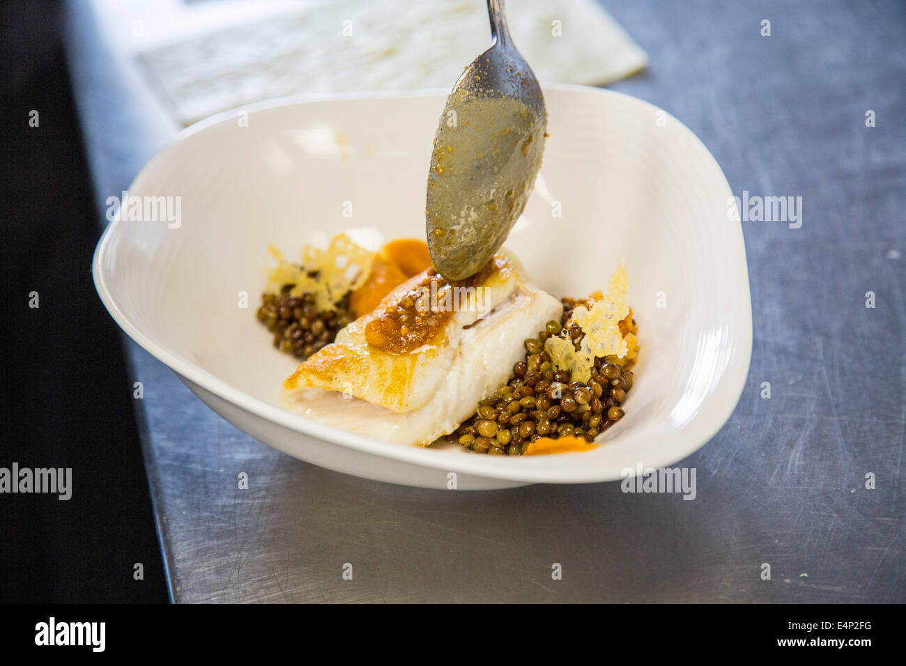 Restaurant kitchen, plate with vegetable puree with lentils, fish ...