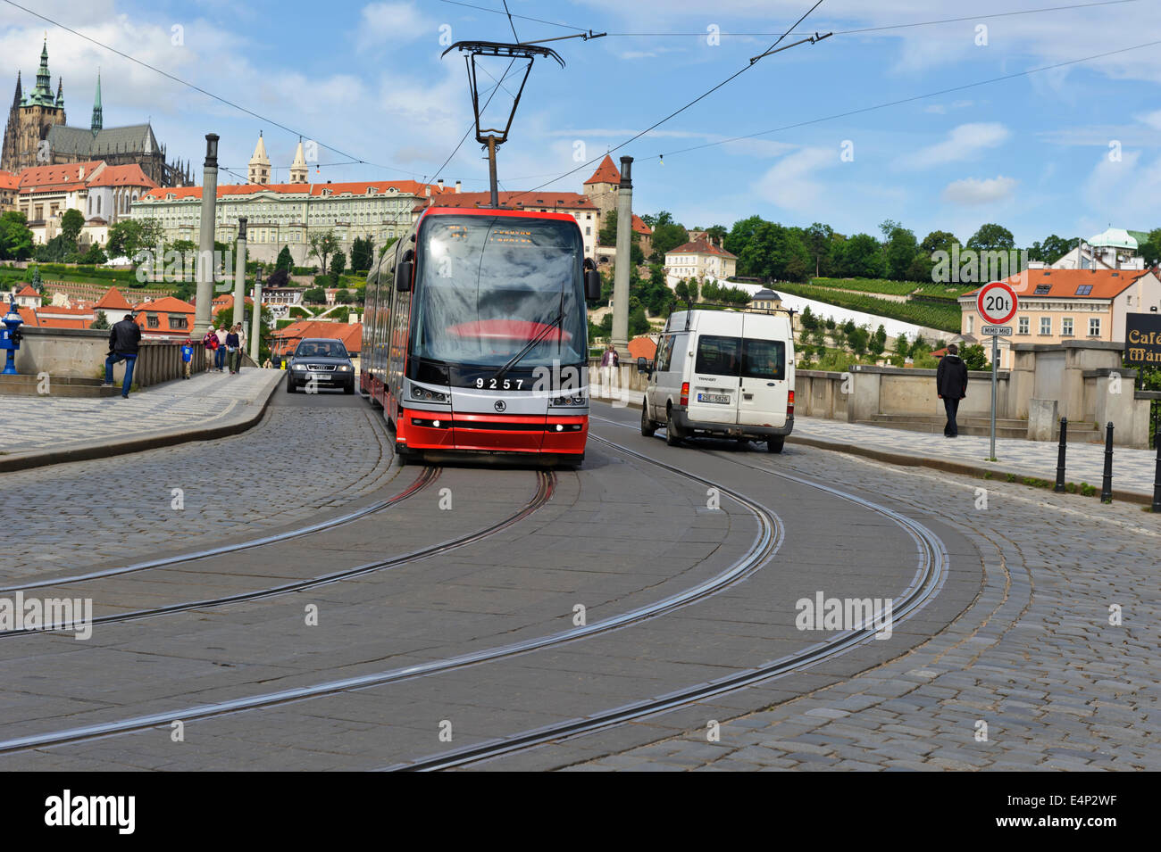 A modern traditional electric tram in Prague with the famous St Vitus ...
