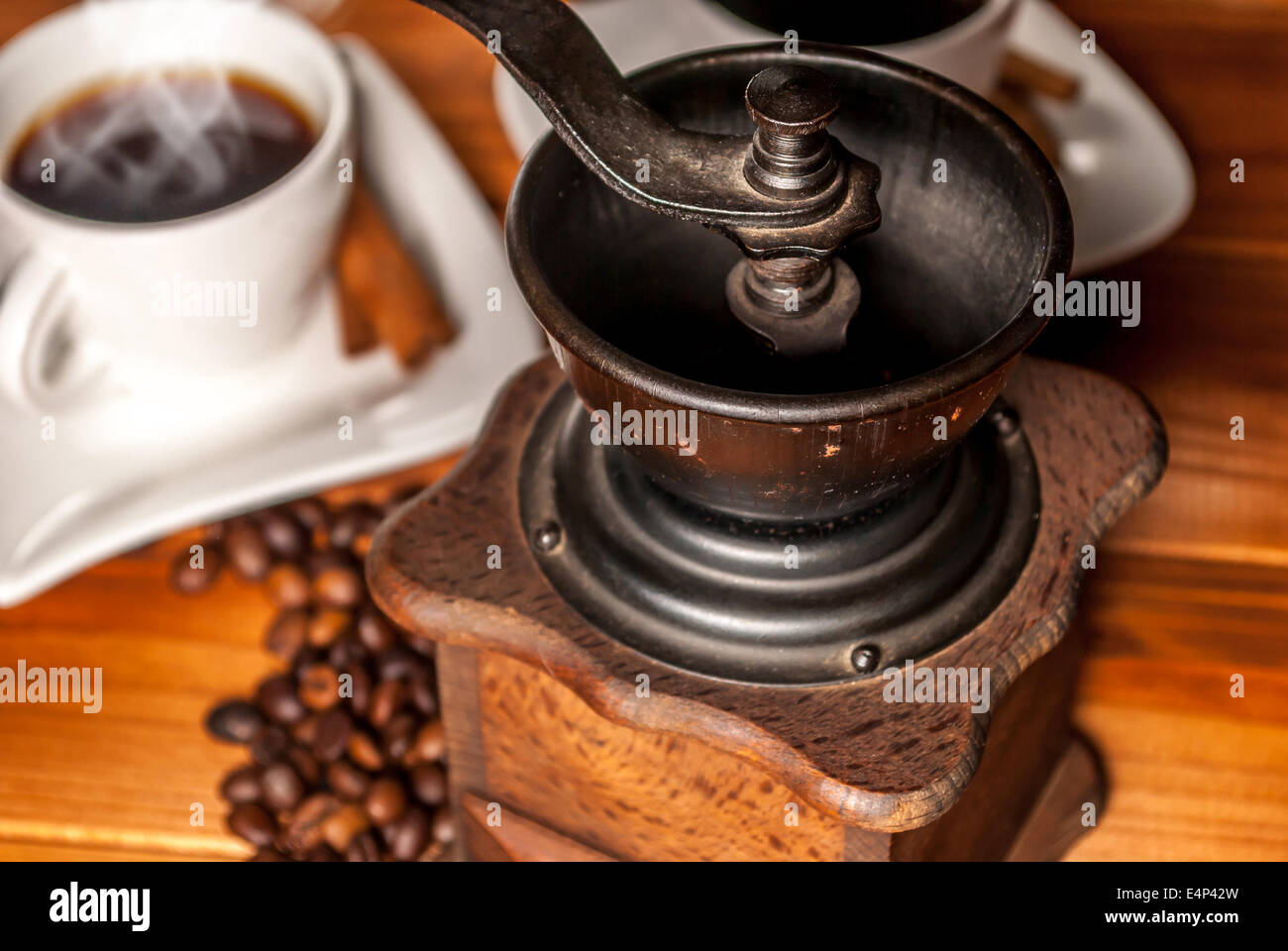 Cup of coffee and cinnamon and ancient grinder Stock Photo - Alamy