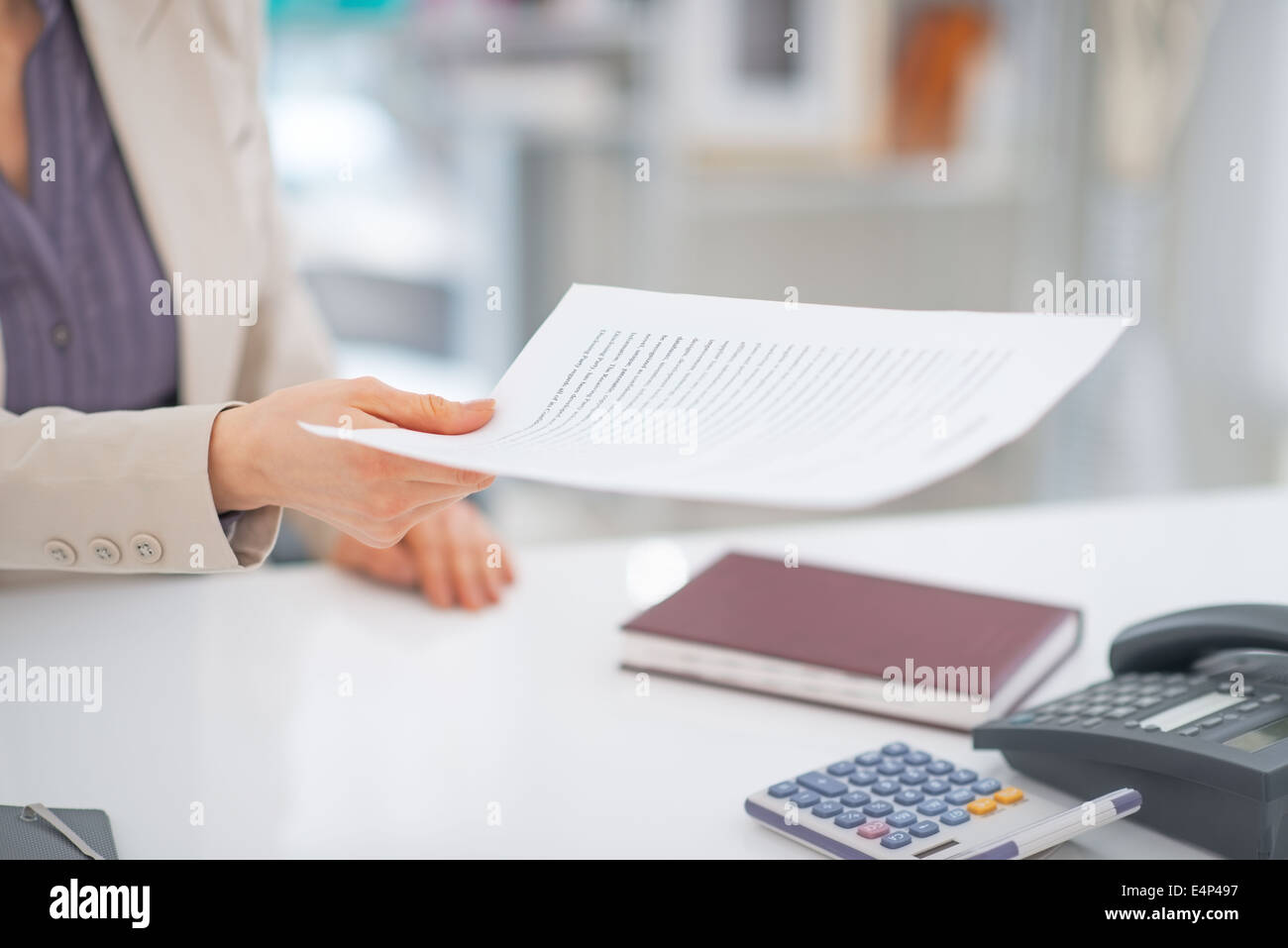 Closeup on business woman giving document Stock Photo - Alamy