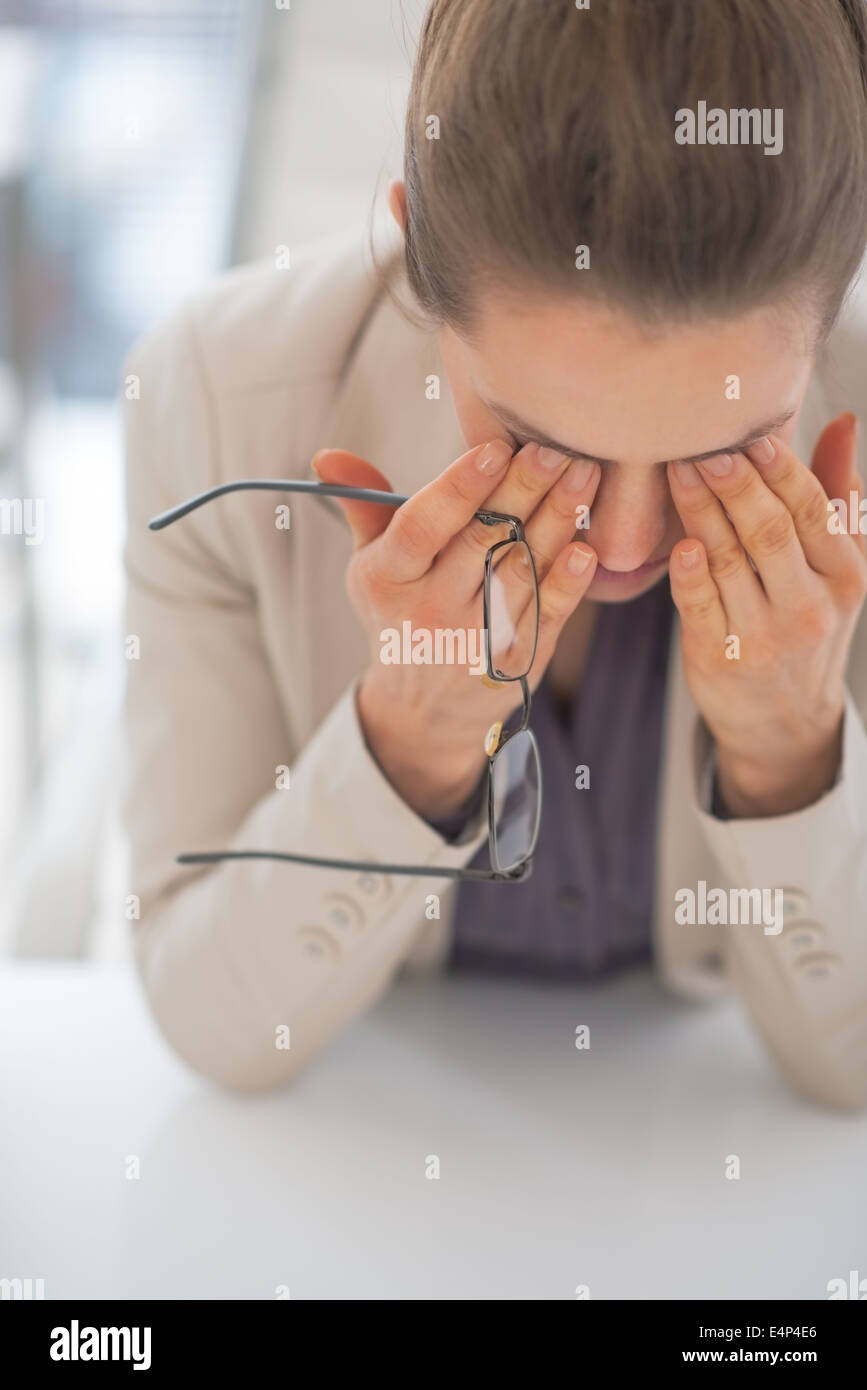 Tired business woman with eyeglasses Stock Photo - Alamy
