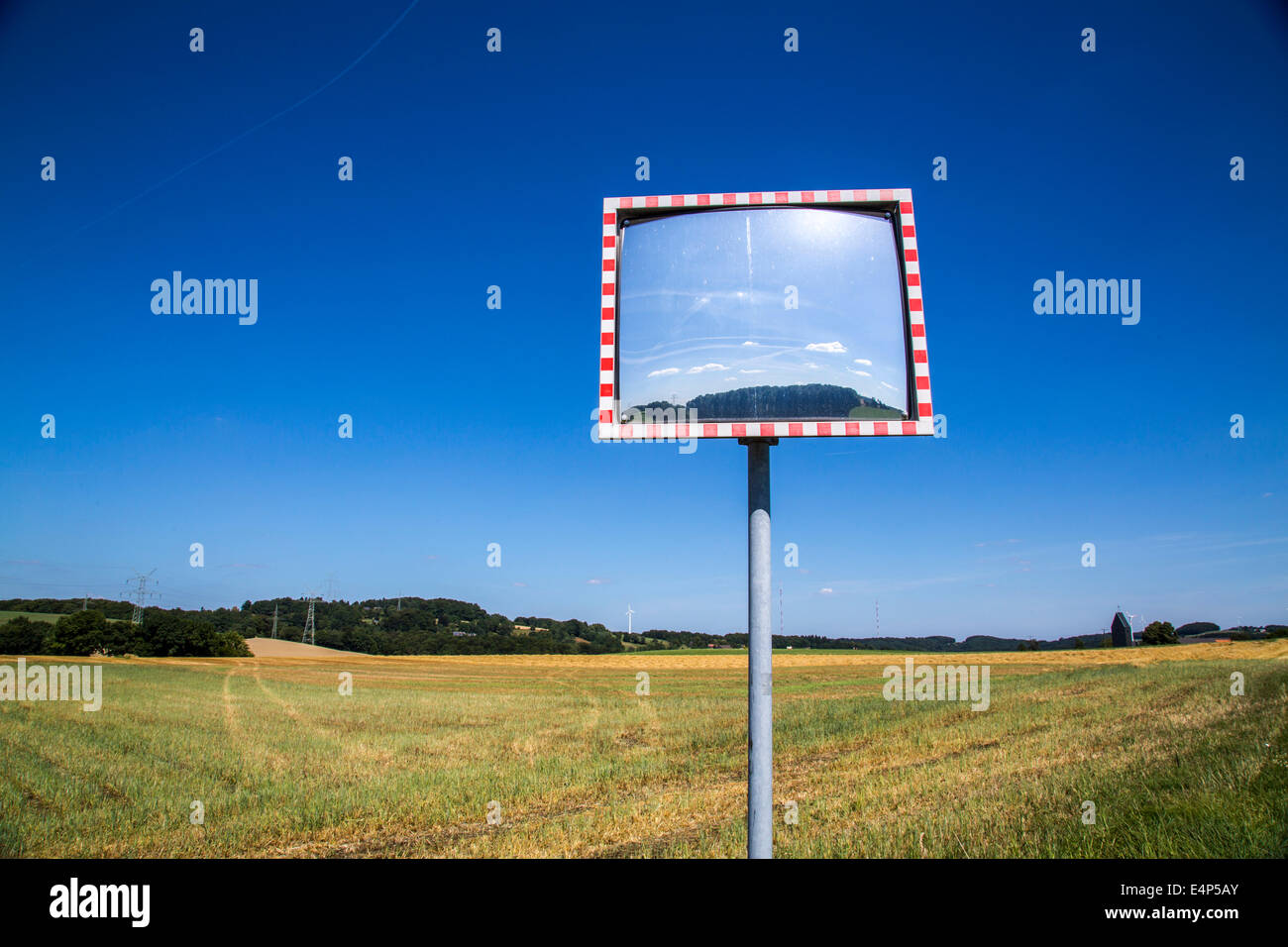 Traffic mirror in the landscape, crossing two road, sky reflected Stock ...