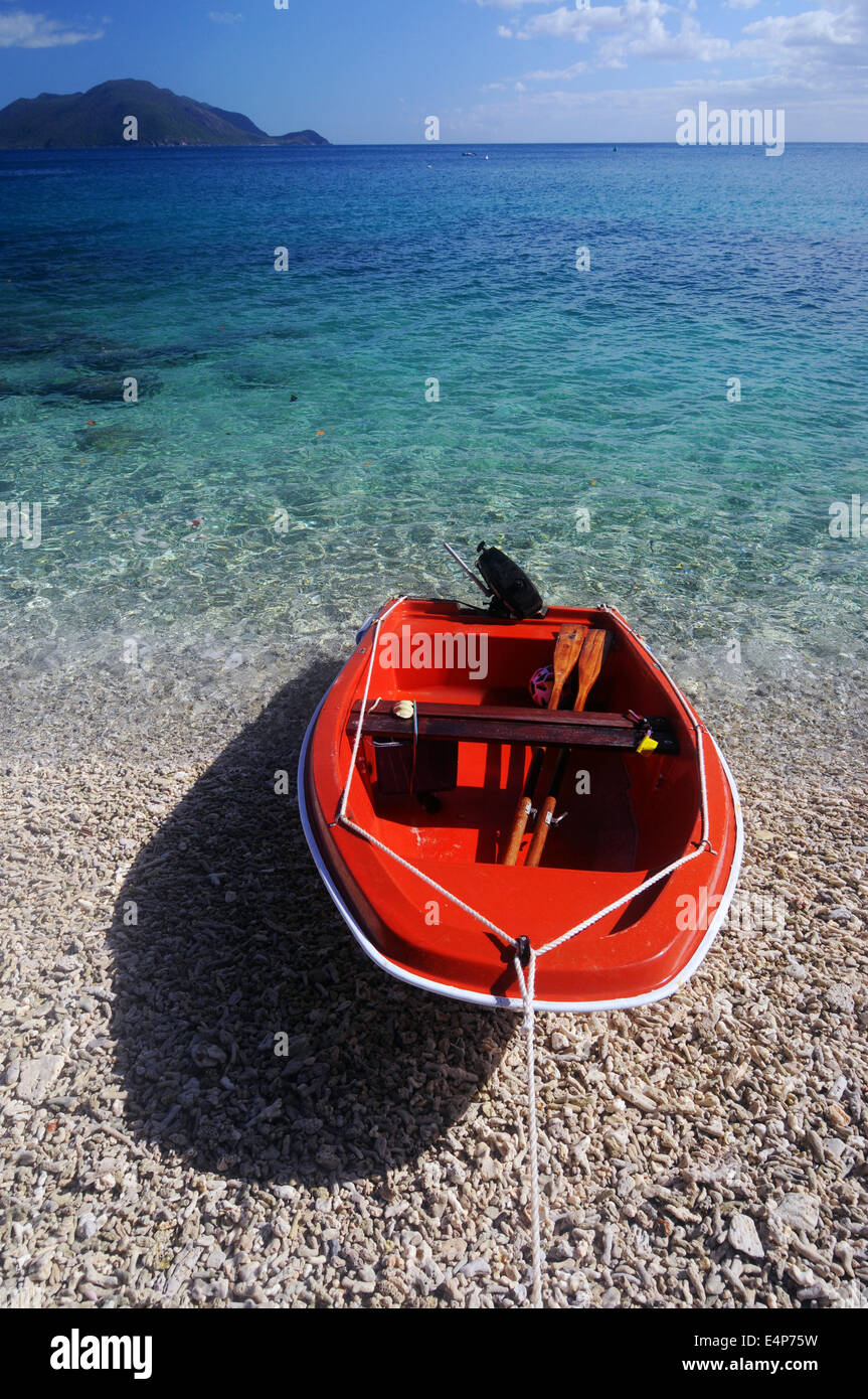 Red dinghy on coral rubble beach, Fitzroy Island, Great Barrier Reef ...