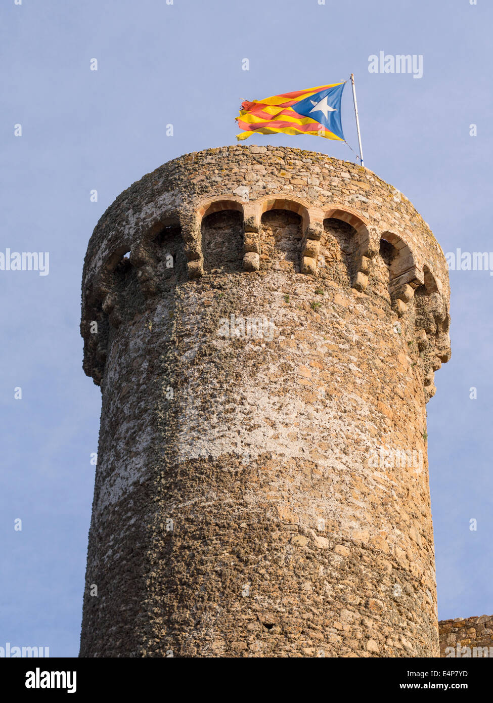 Tower of Tossa de Mar topped by a Catalonian Flag. The massive stone ...