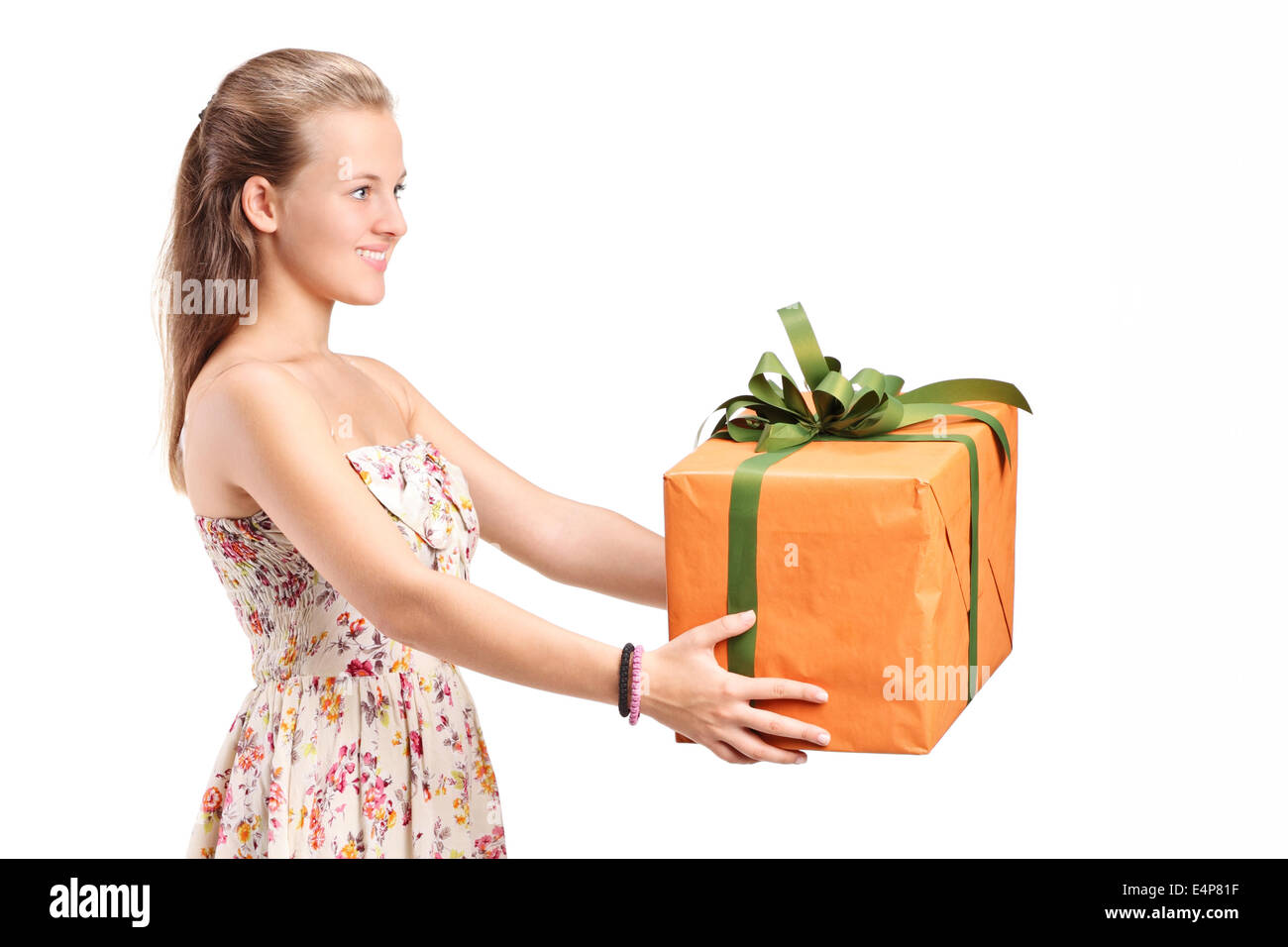 Young woman holding a big present Stock Photo - Alamy
