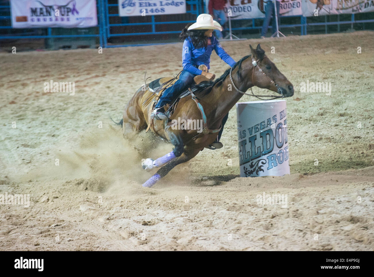 Cowgirl Participating in a Barrel racing competition at the Helldorado ...