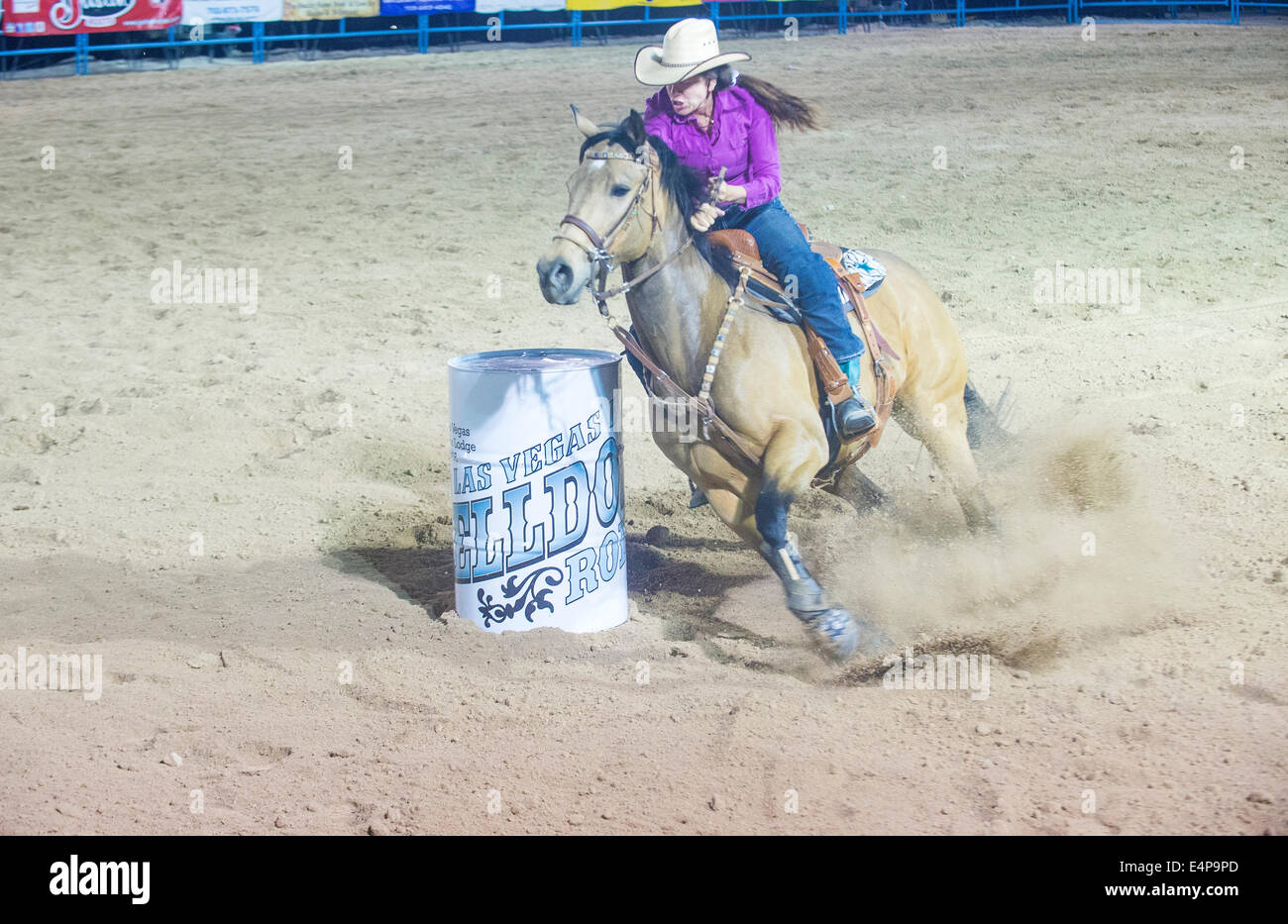 Cowgirl Participating in a Barrel racing competition at the Helldorado ...
