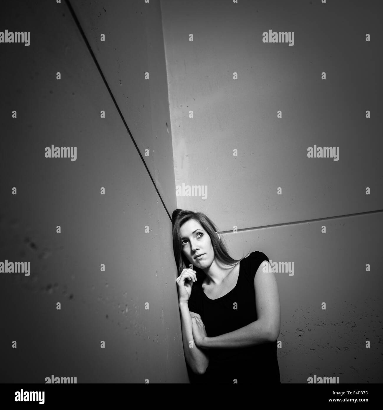 Young woman suffering from a severe depression (very harsh lighting is ...