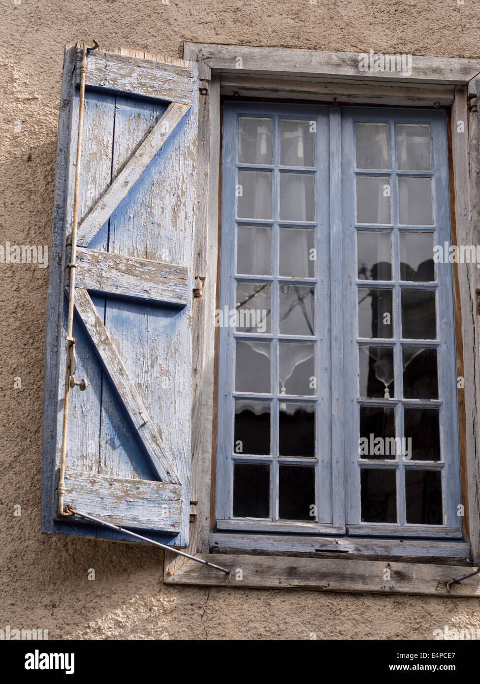 Blue Shutter, Blue Window. A weathered blue shutter for a multi-paned ...
