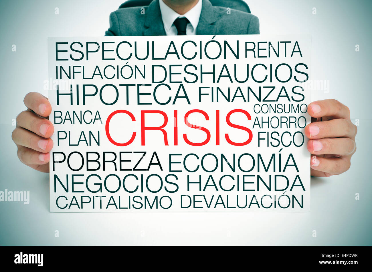A Businessman Holding A Signboard With Different Terms In Spanish a-businessman-holding-a-signboard-with-different-terms-in-spanish