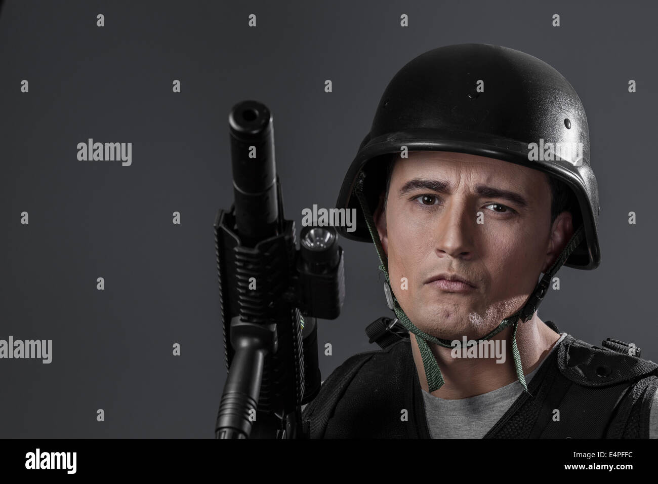 Security, paintball sport player wearing protective helmet aiming ...