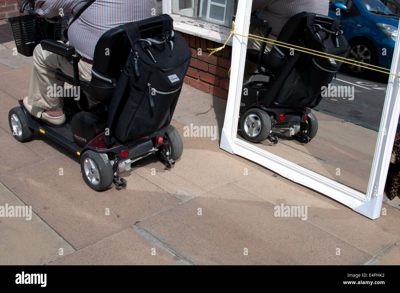 Mobility scooter, reflected in a mirror Stock Photo - Alamy